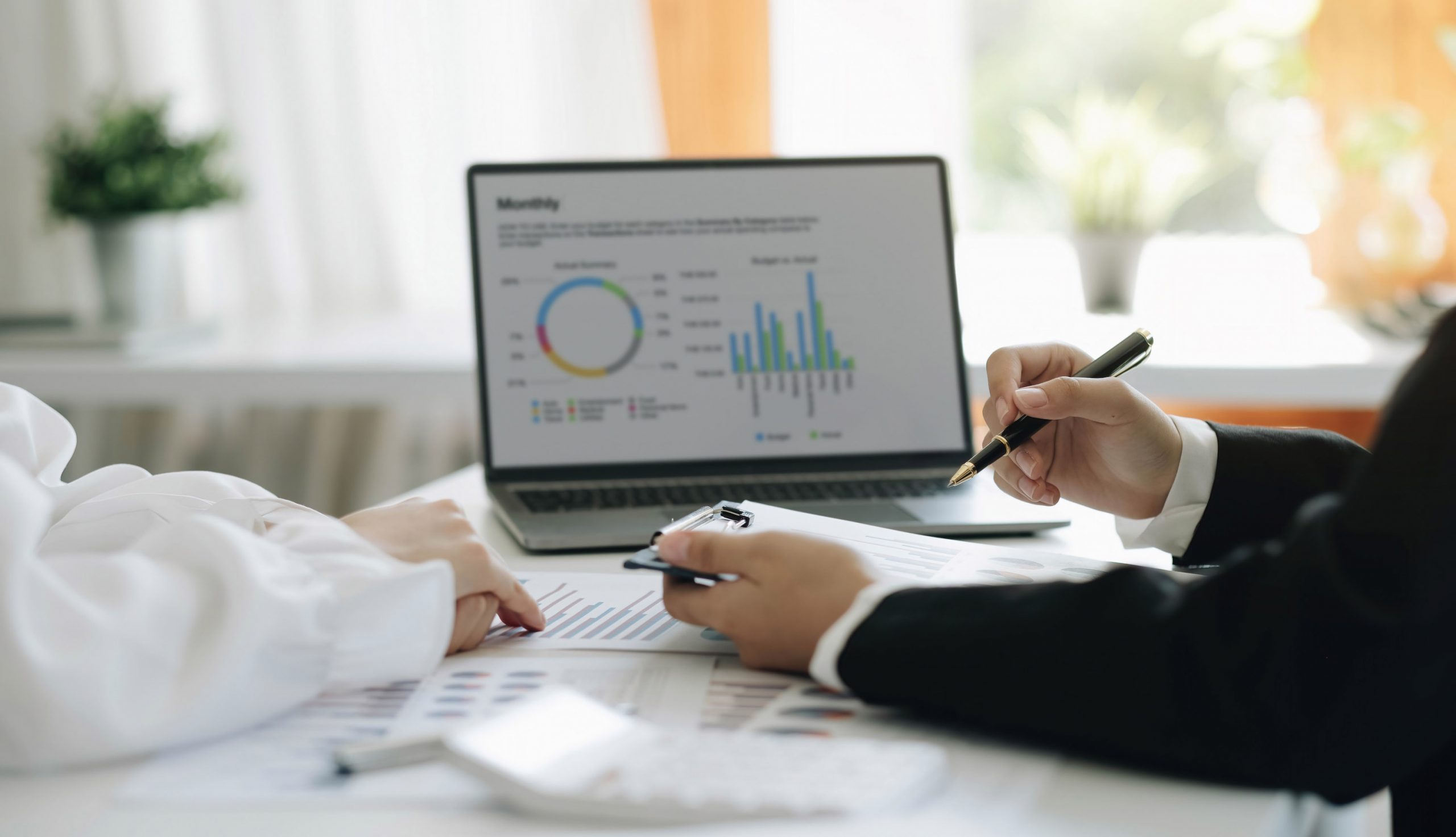 Team businesswoman studying statistics and holding a graph document by ...
